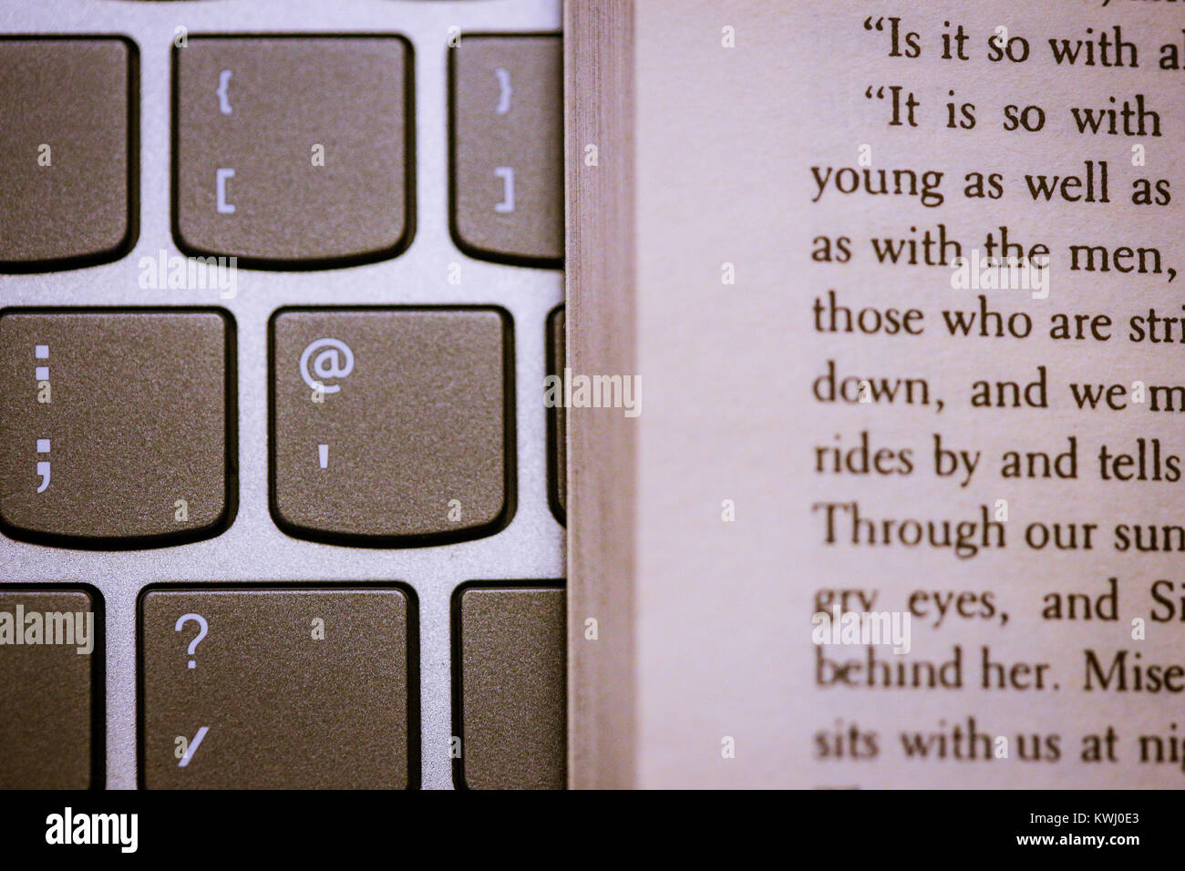 Closeup of classical english book on laptop keyboard - print versus ...