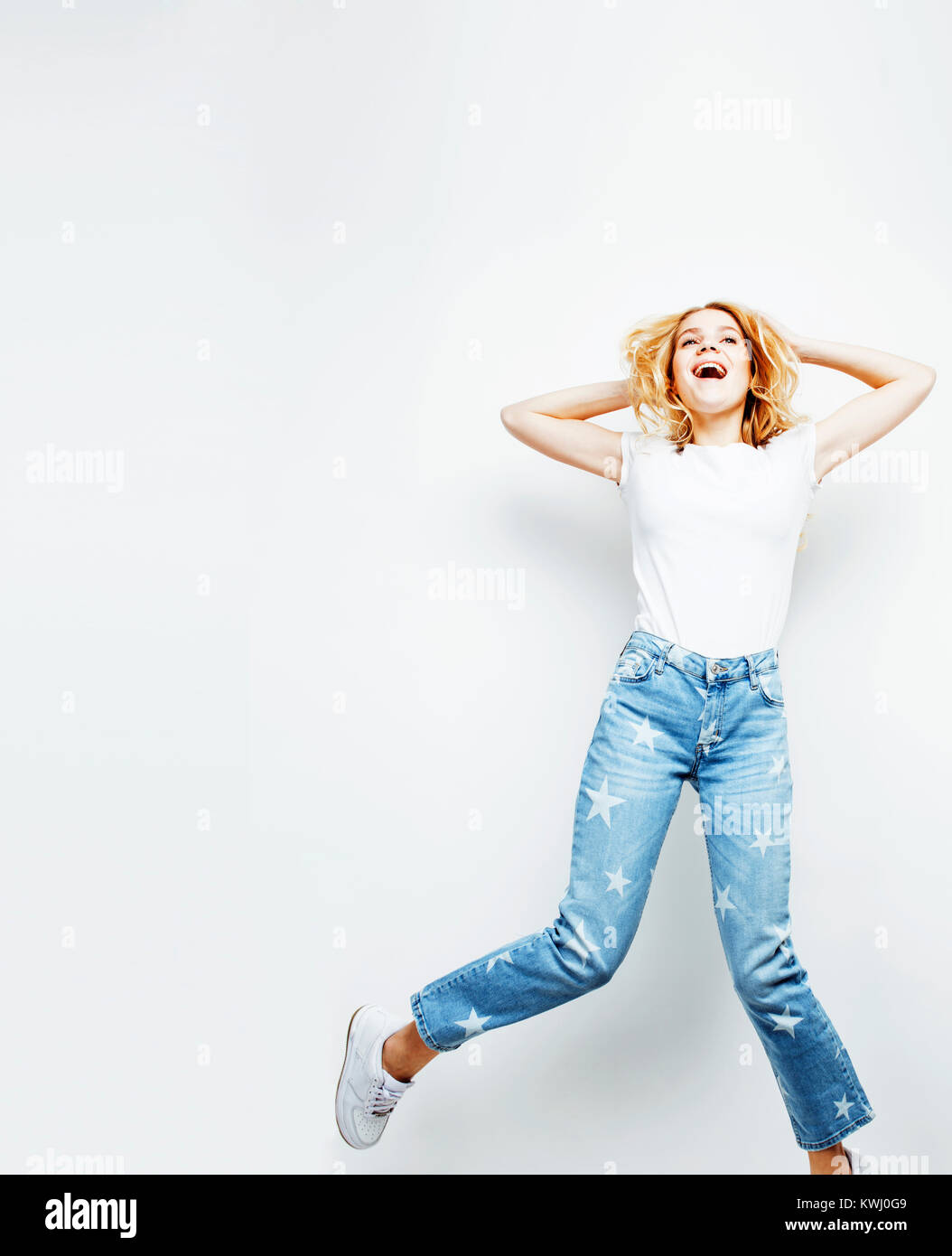 young pretty teenage girl jumping cheerful isolated on white background ...