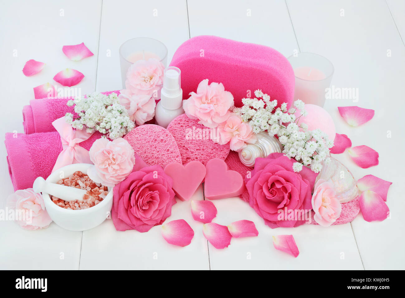 Spa beauty treatment products with a pink rose and carnation flowers ...