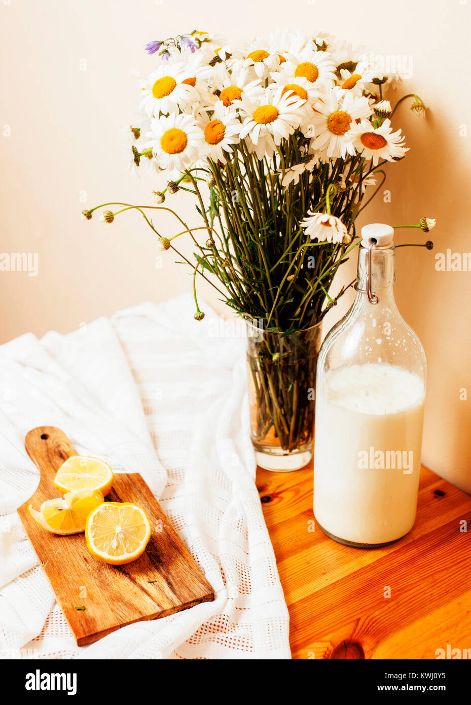 Simply stylish wooden kitchen with bottle of milk and glass on table ...