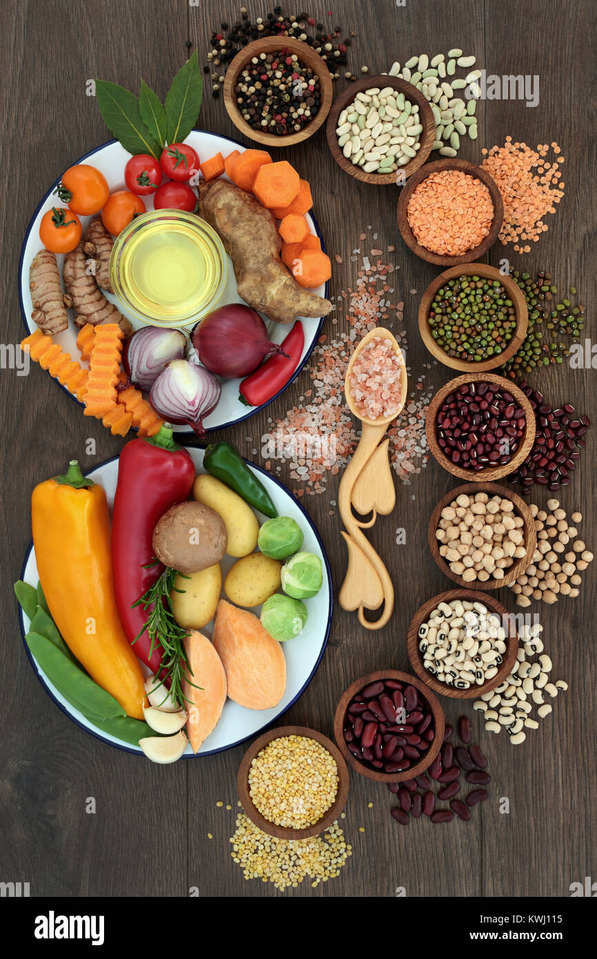 Health food concept with fresh vegetables, pulses, herbs, spice ...