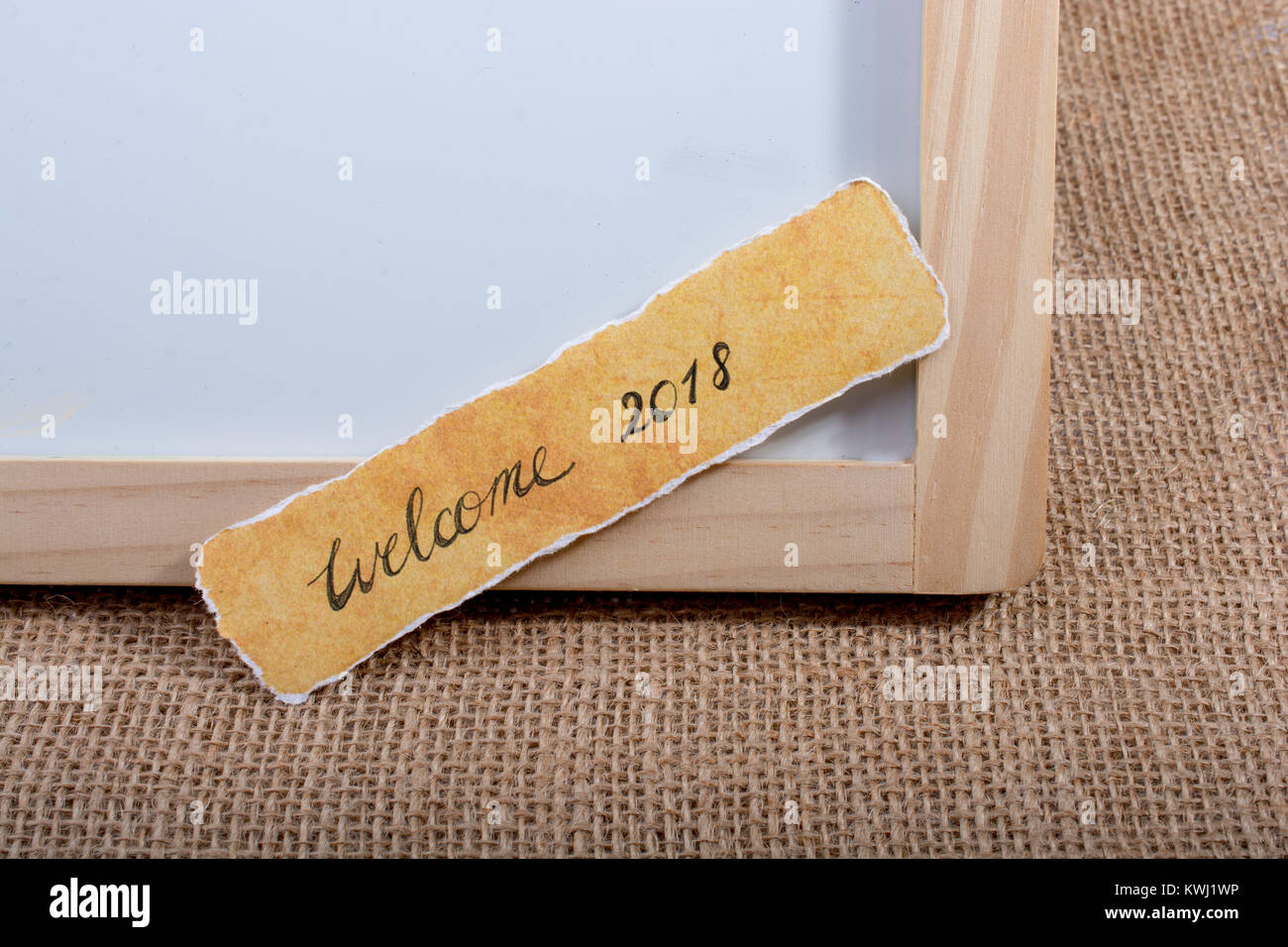 Welcome 2018 wording written on a torn paper Stock Photo - Alamy