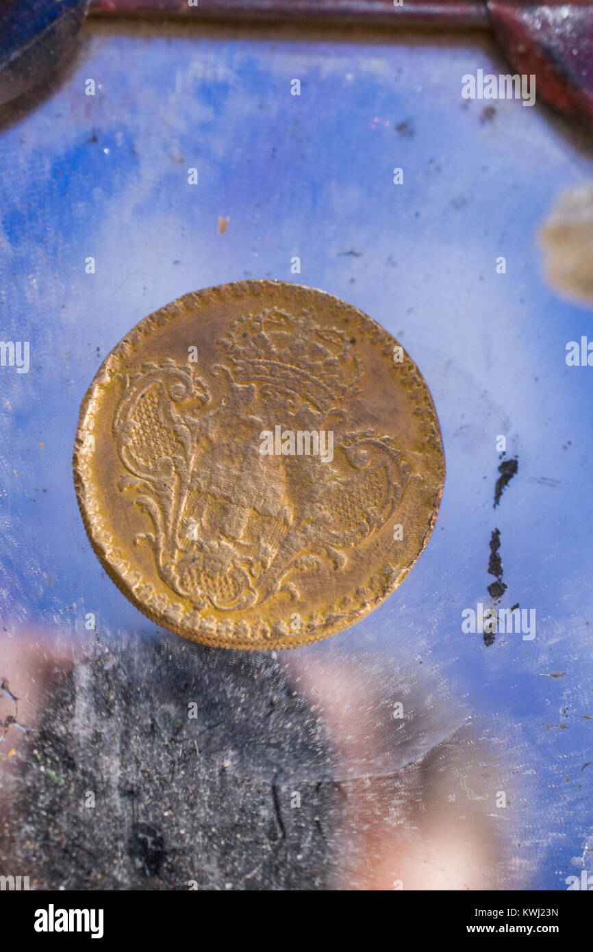 Ancient gold color metal coin in view Stock Photo - Alamy
