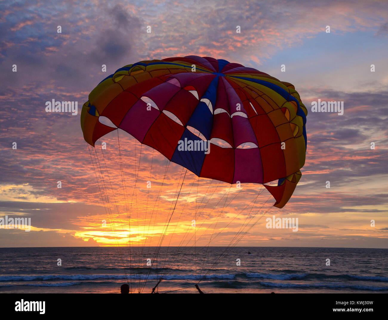 Parasailing in the mystery sky at sunset on Patong Beach of Phuket ...