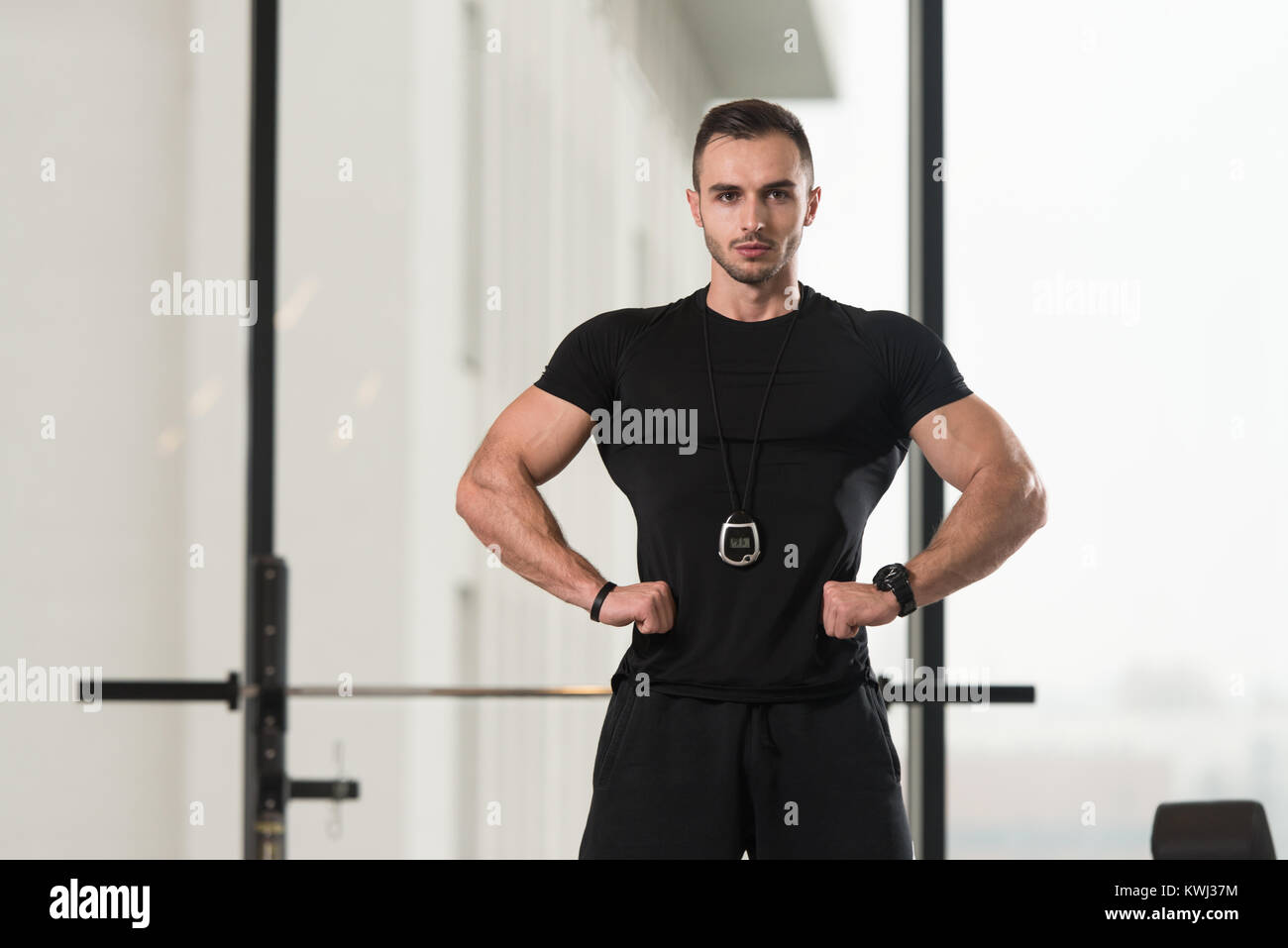 Handsome Personal Trainer With Stopwatch In A Fitness Center Gym ...