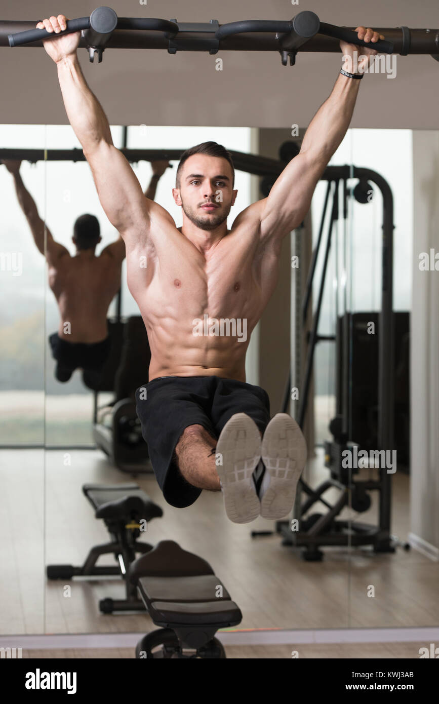 Athlete Performing Hanging Leg Raises Exercise - One Of The Most ...