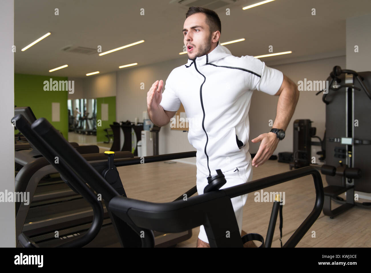 Handsome Man Running On The Treadmill In Gym Stock Photo - Alamy