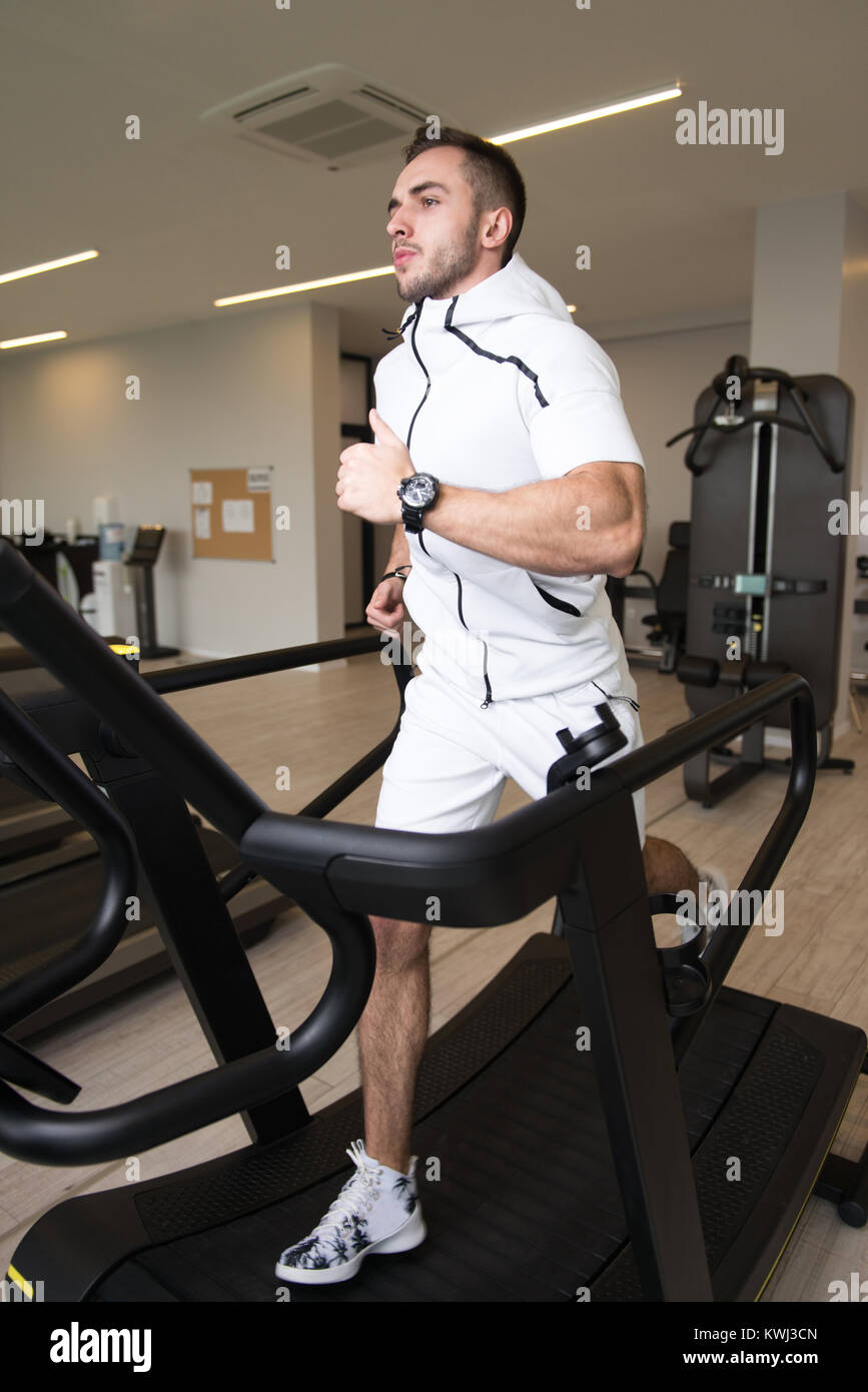Handsome Man Running On The Treadmill In Gym Stock Photo - Alamy