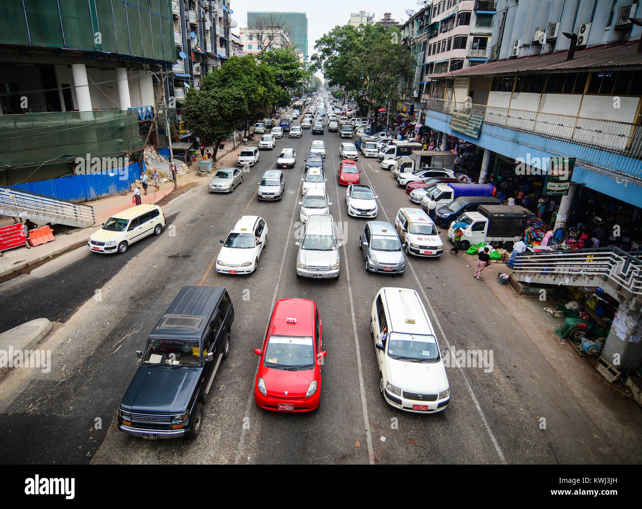 Yangon, Myanmar - Feb 26, 2016. Cars running on street at downtown in ...