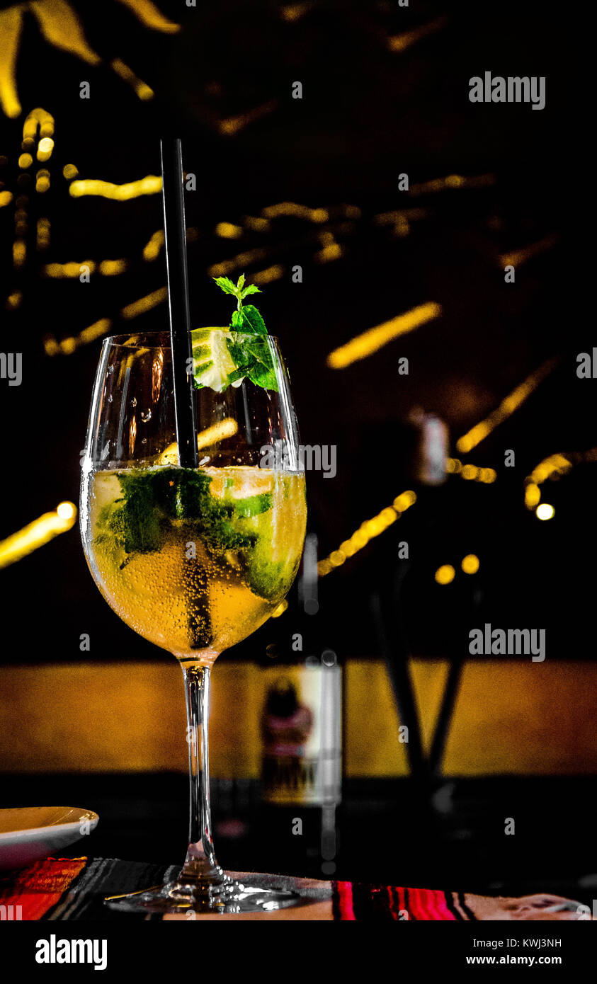 Refreshing glass of Mojito in dim light, pub bar setting Stock Photo ...