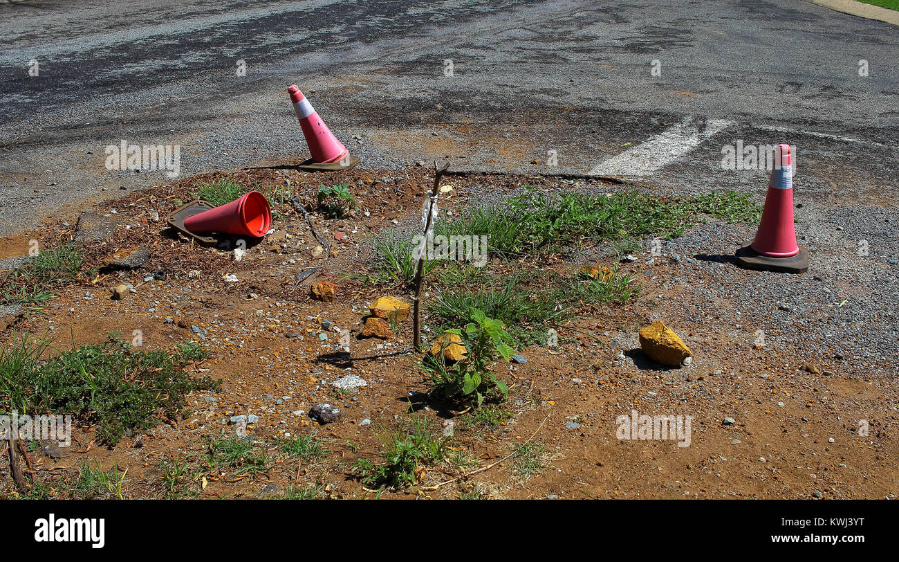 A collapsed section of tar road surface that has not been repaired ...