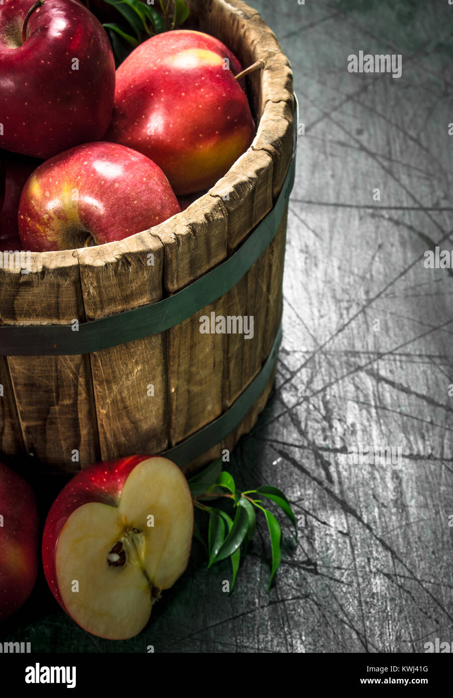 Red apples in a wooden bucket. On a rustic background Stock Photo - Alamy