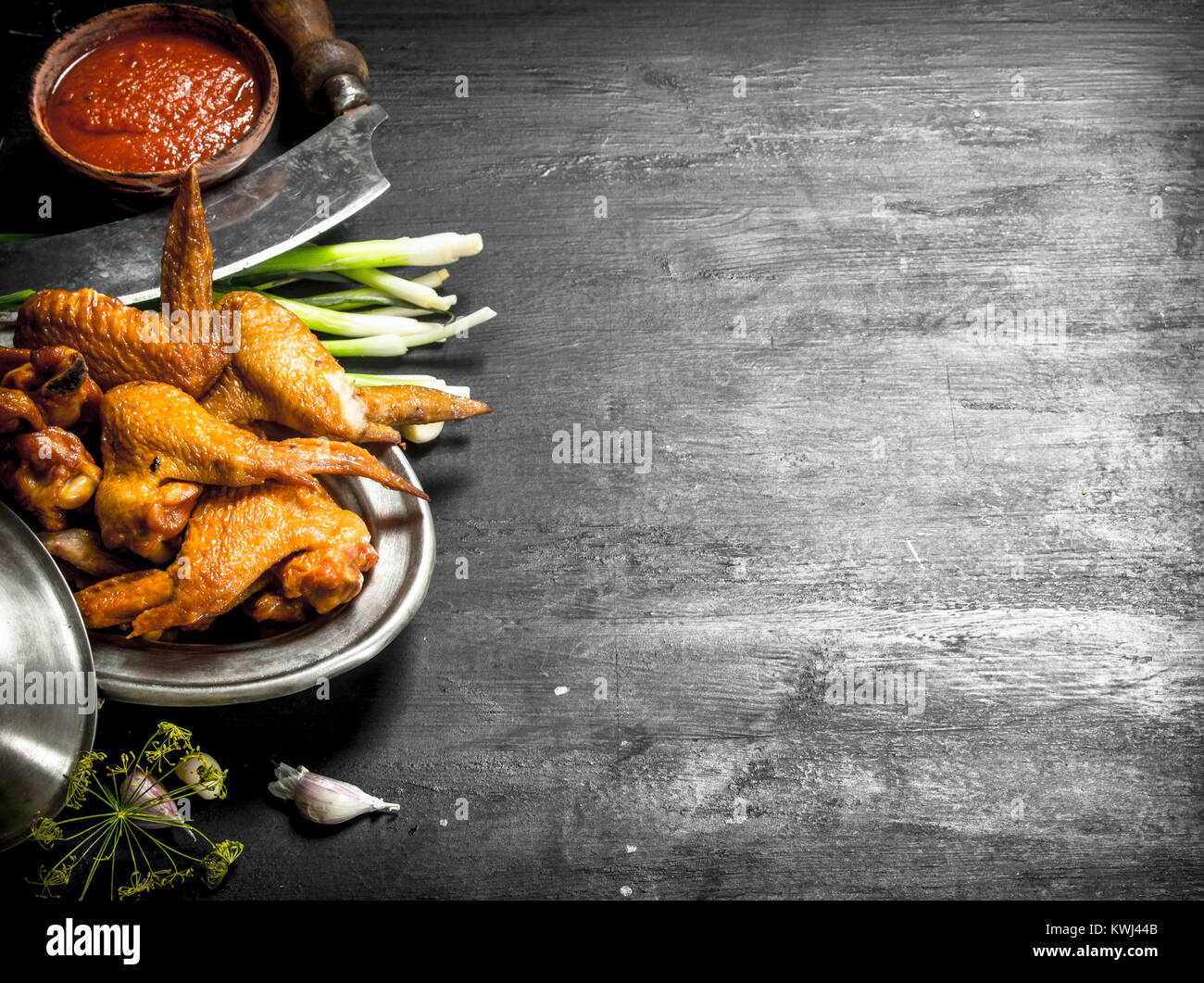 Chicken wings smoked. On the black chalkboard Stock Photo - Alamy