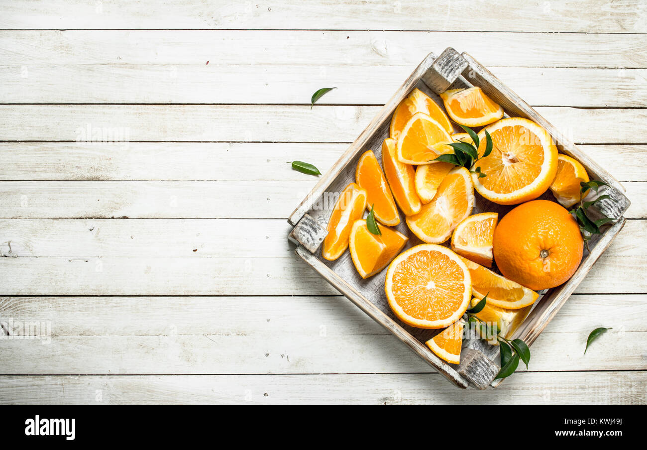Fresh oranges in a box. On a white wooden table Stock Photo - Alamy