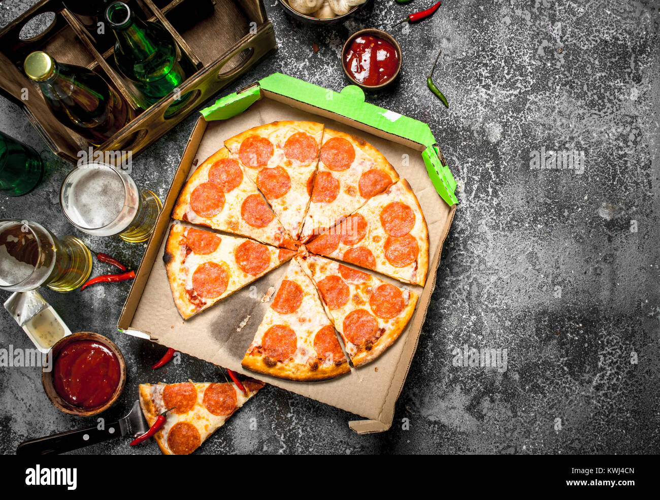 Pizza background. Pepperoni with beer. On a rustic background Stock ...