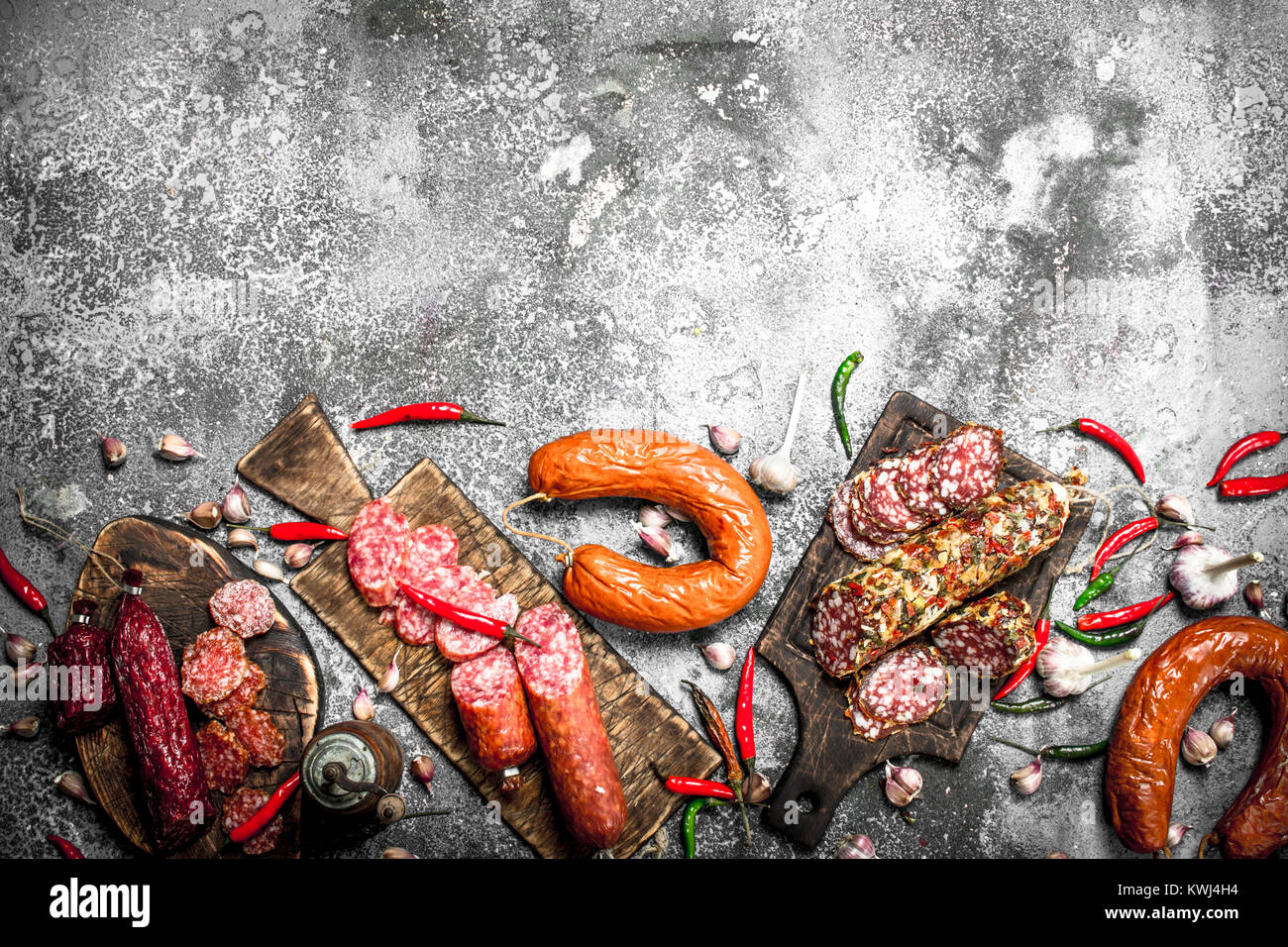 Salami background. Different kinds of salami with spices. On a rustic ...