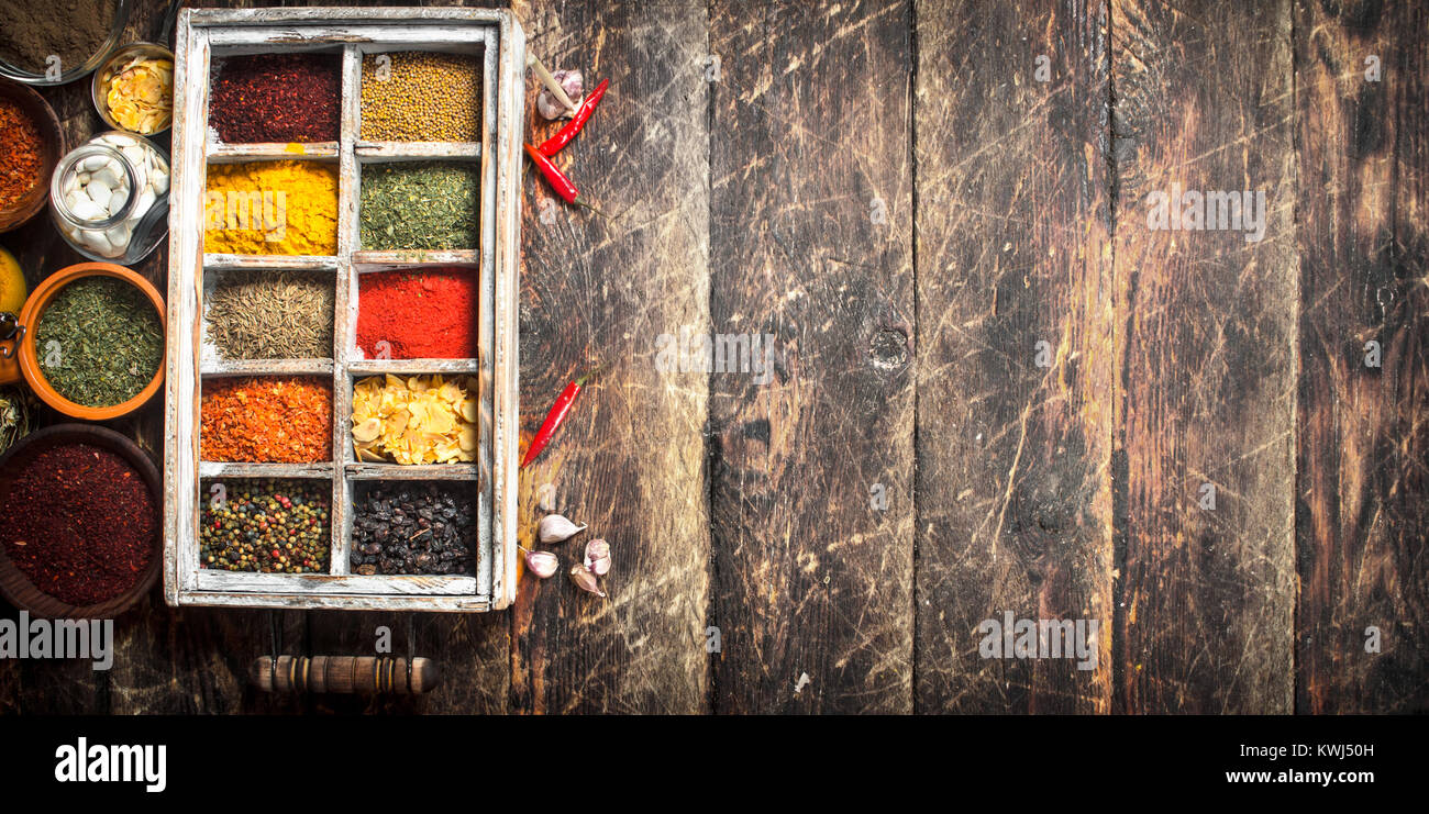 Different spices and herbs in a box. On a wooden background Stock Photo ...