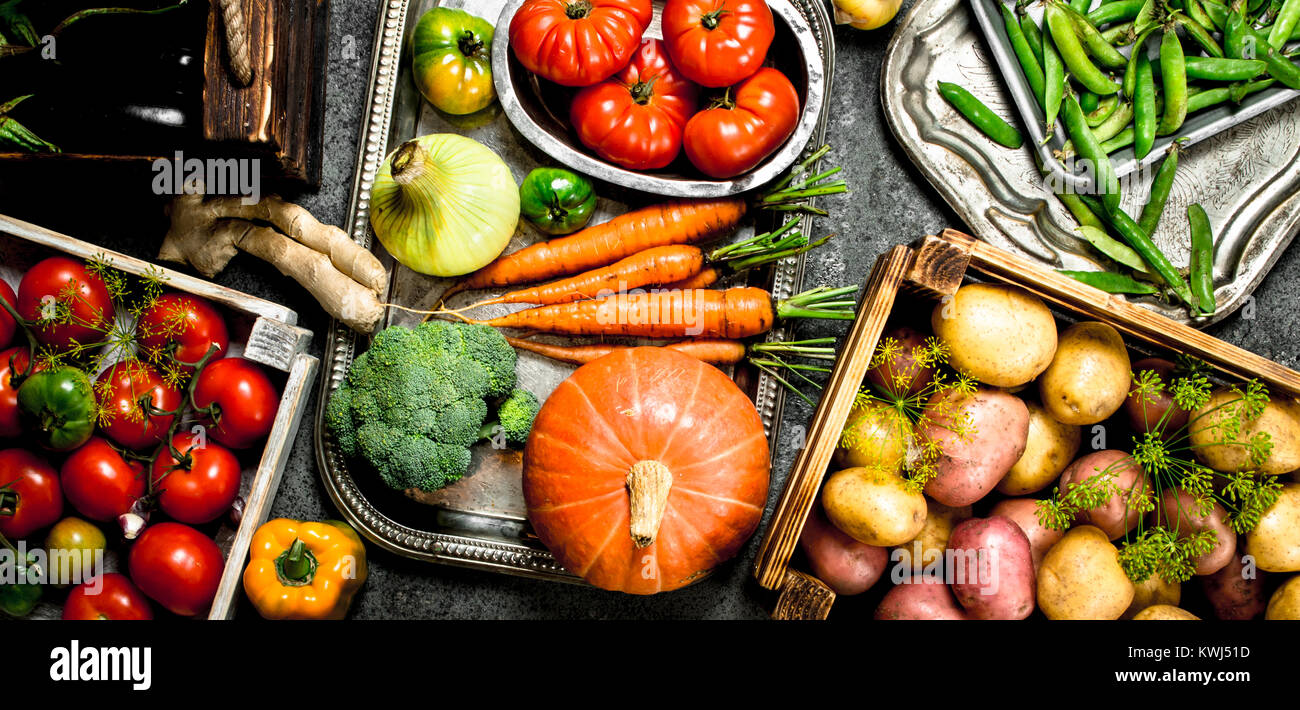 Organic food. Fresh crop of vegetables in boxes. On a rustic background ...