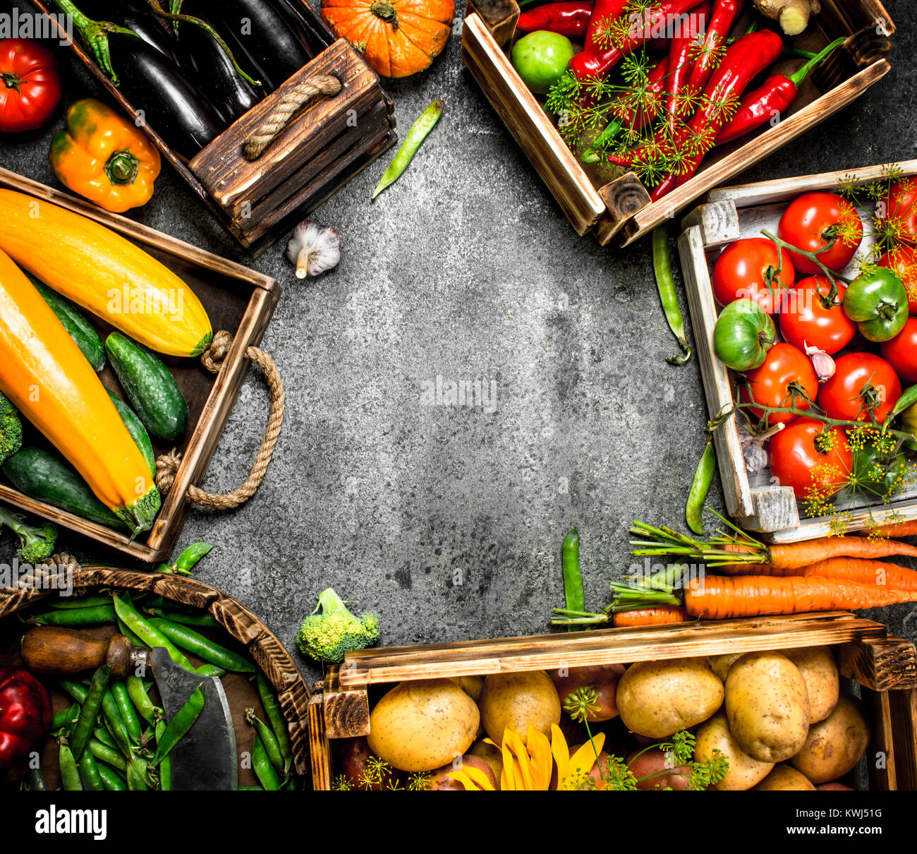 Organic food. Fresh crop of vegetables in boxes. On a rustic background ...