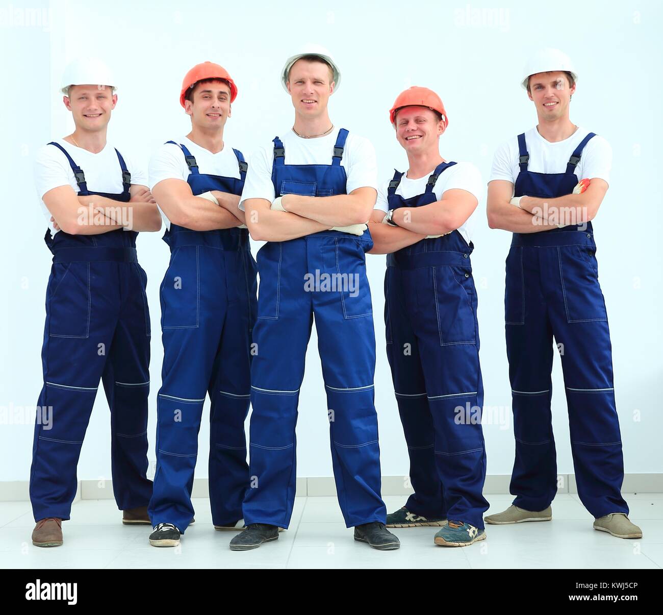 team of professional builders in helmets Stock Photo - Alamy
