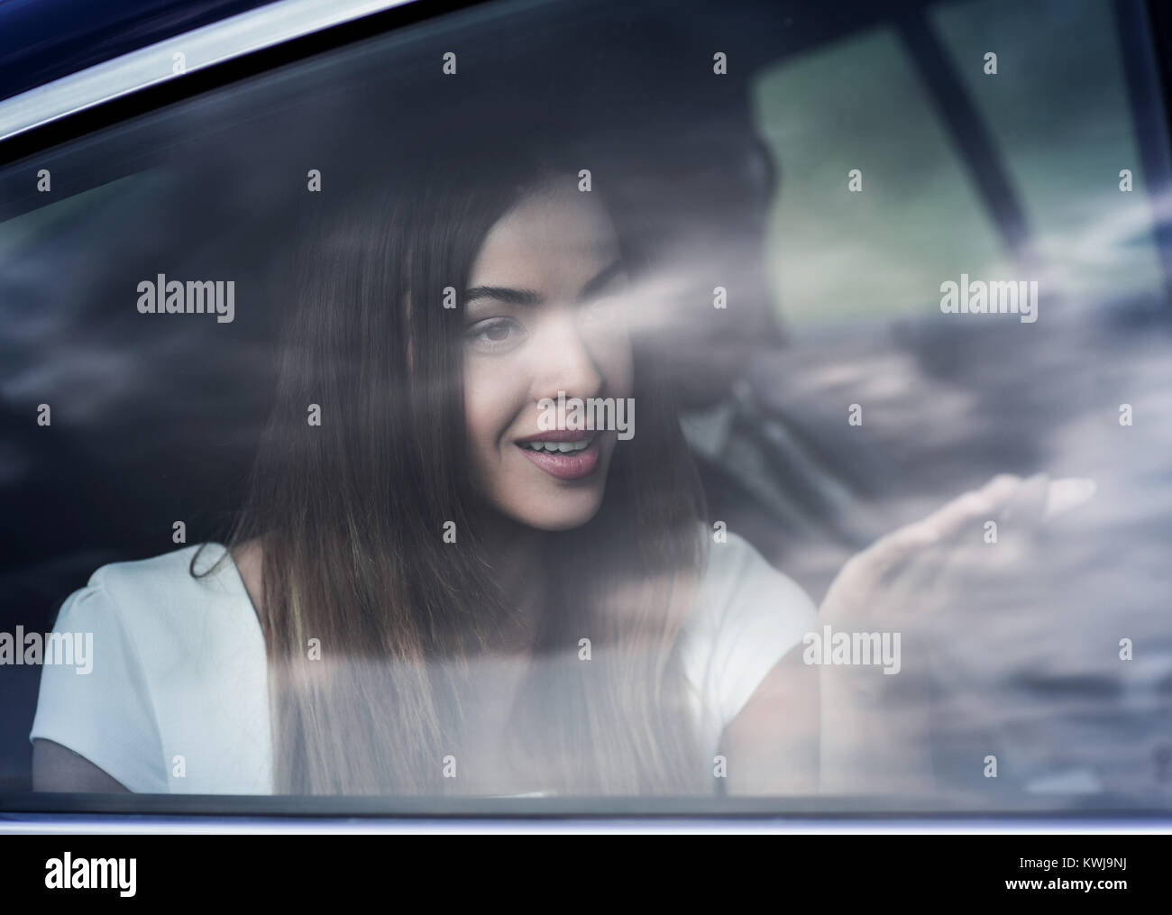 young woman portrait in the car behind the window Stock Photo - Alamy