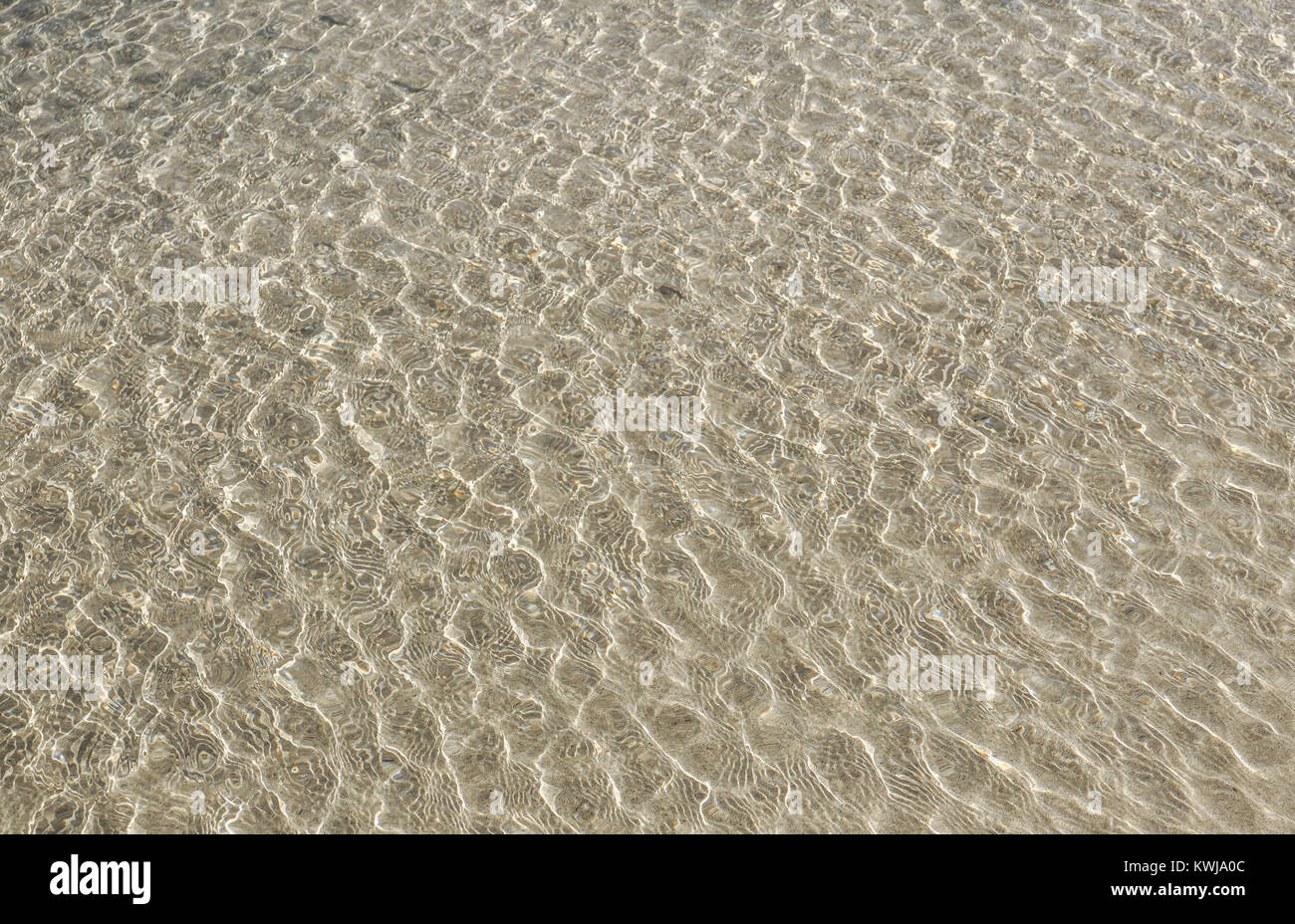 Clear water above sand bottom on wind. Sand waves sunbeams Stock Photo ...