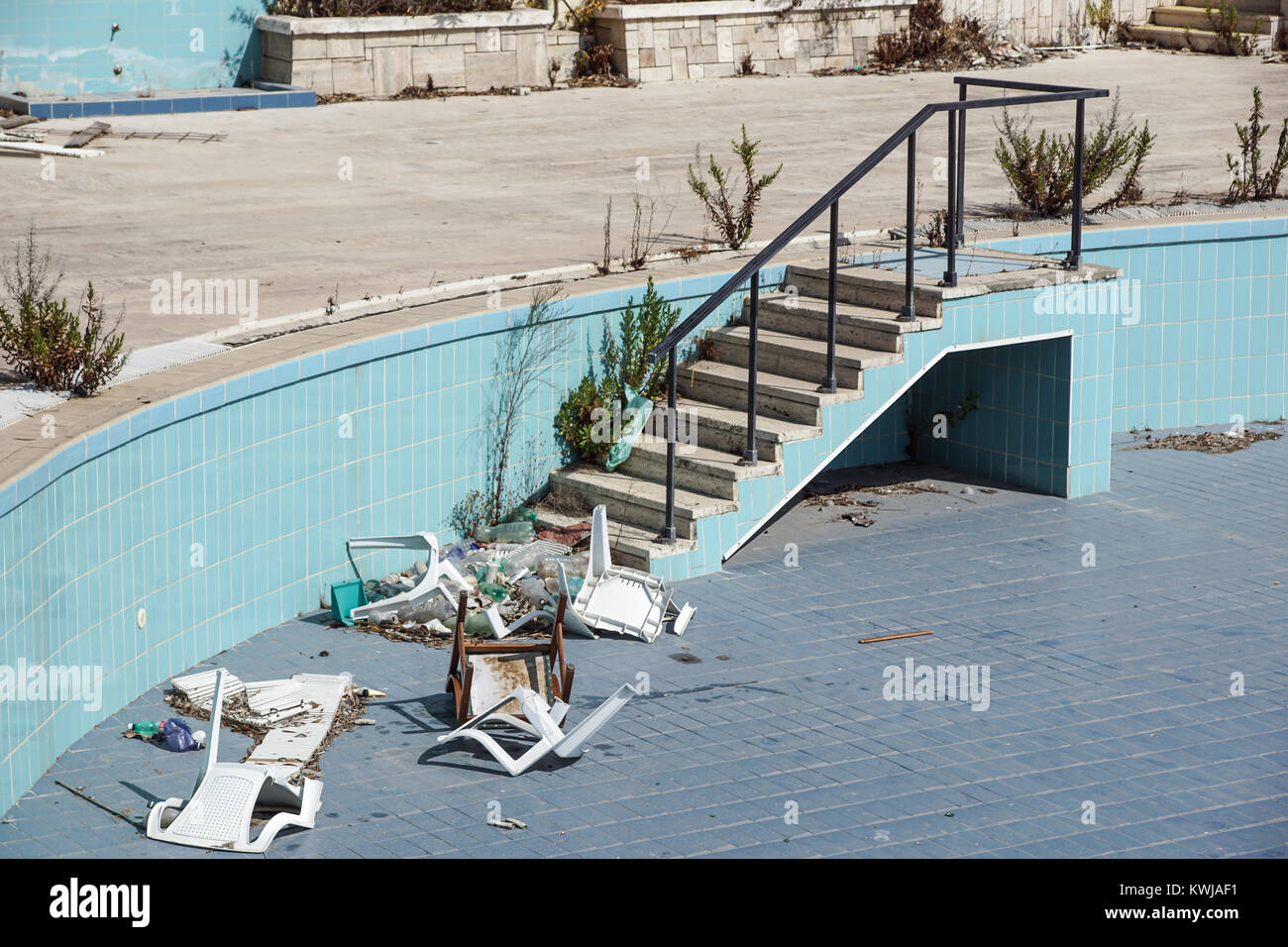 A swimming pool empties and damage at the end of tourist season Stock ...