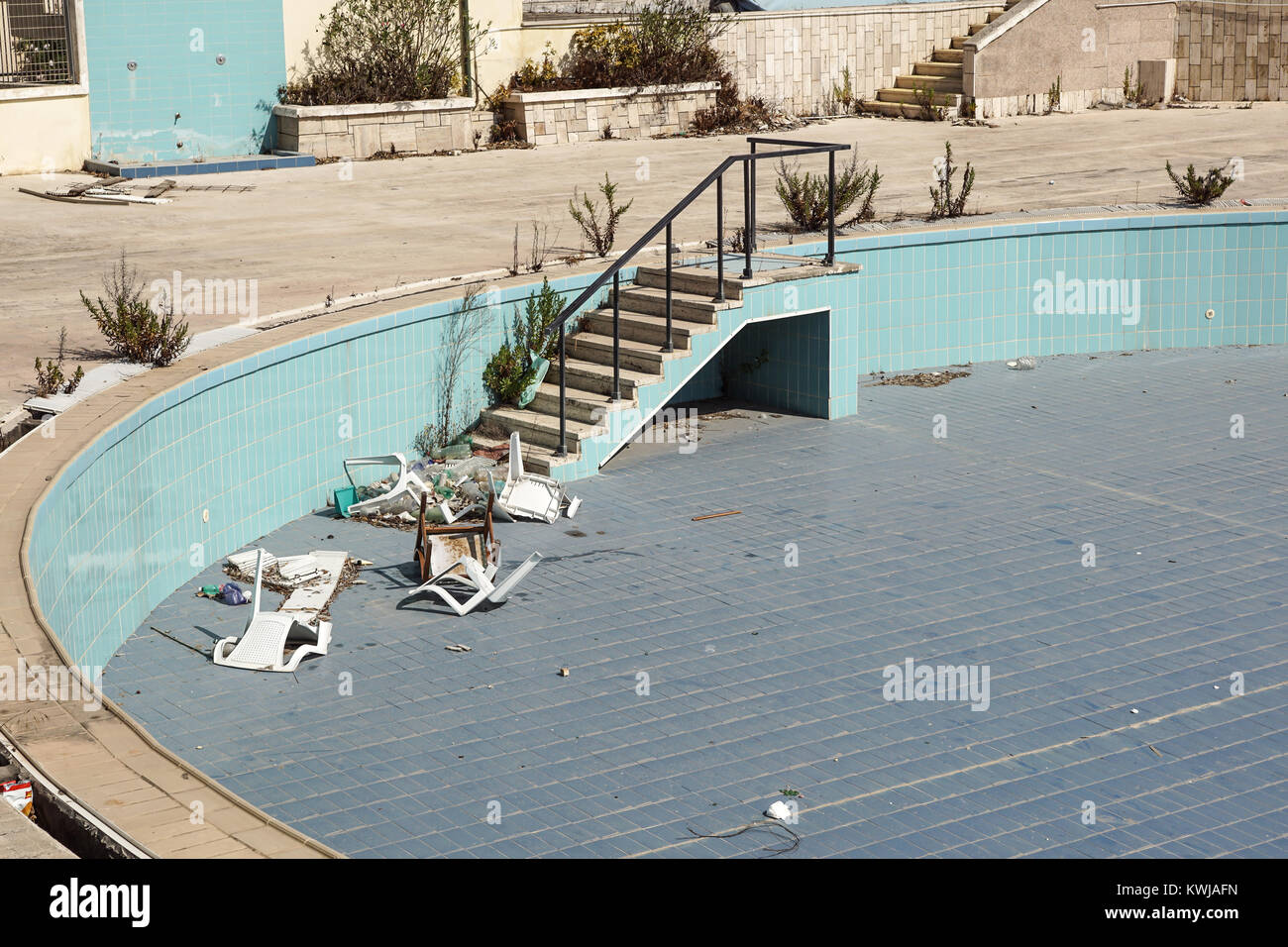 A swimming pool empties and damage at the end of tourist season Stock ...