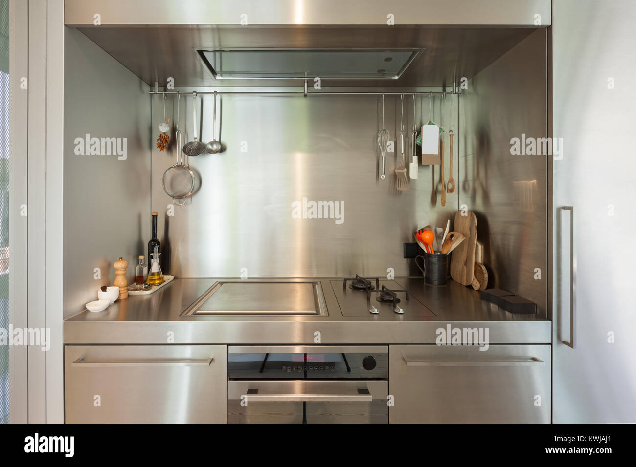 Domestic stainless steel kitchen, hob with objects Stock Photo - Alamy
