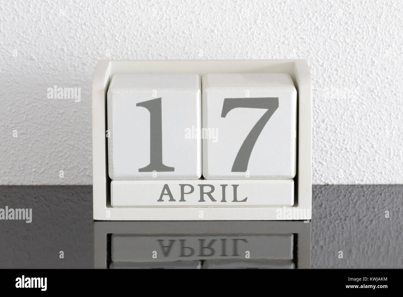 White block calendar present date 17 and month April on white wall ...