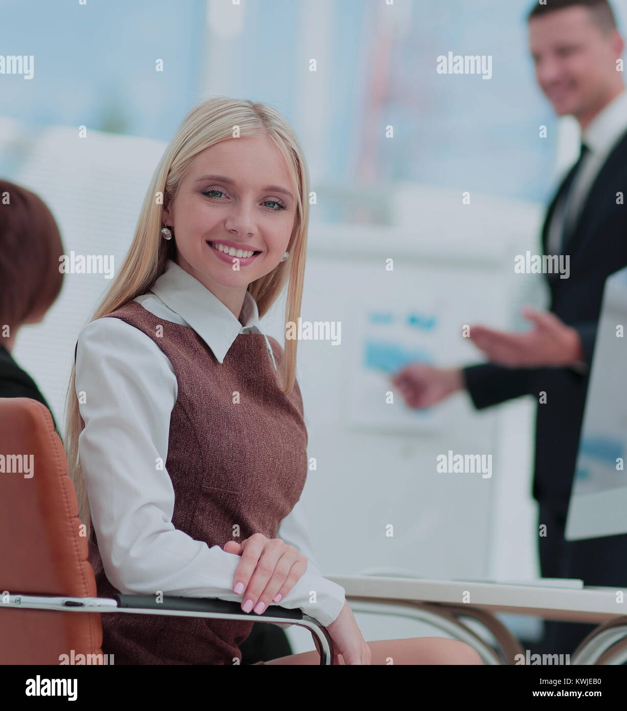 Business woman looking at camera while attractive man making a Stock ...