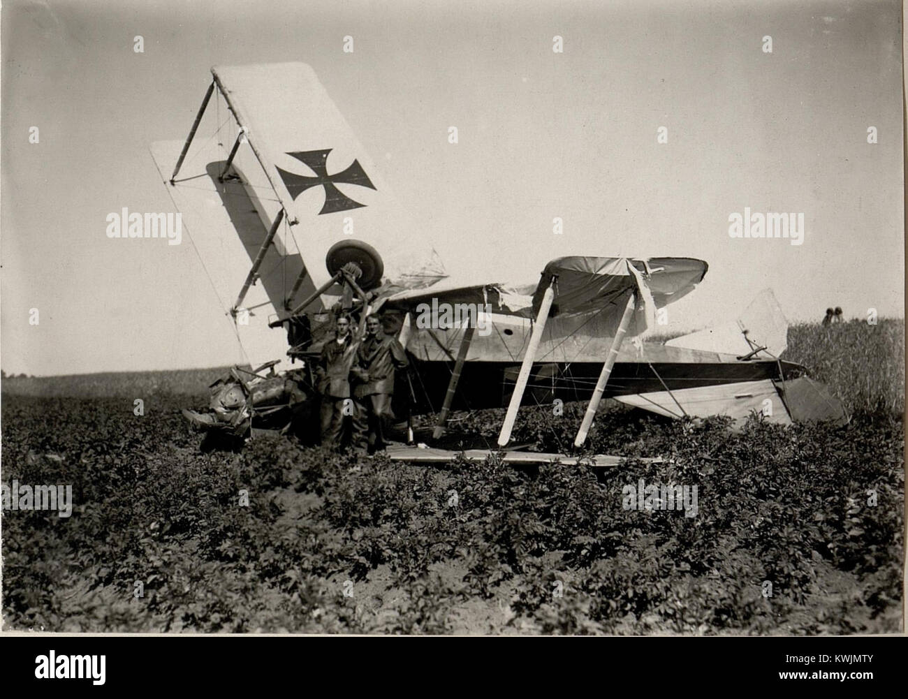 This image depicts a destroyed aircraft with its pilot and observer ...