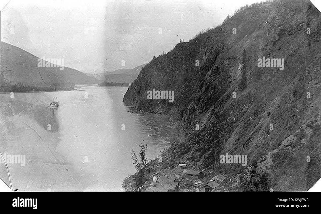 A historical photograph from 1899 showing cabins and a steamboat on the ...
