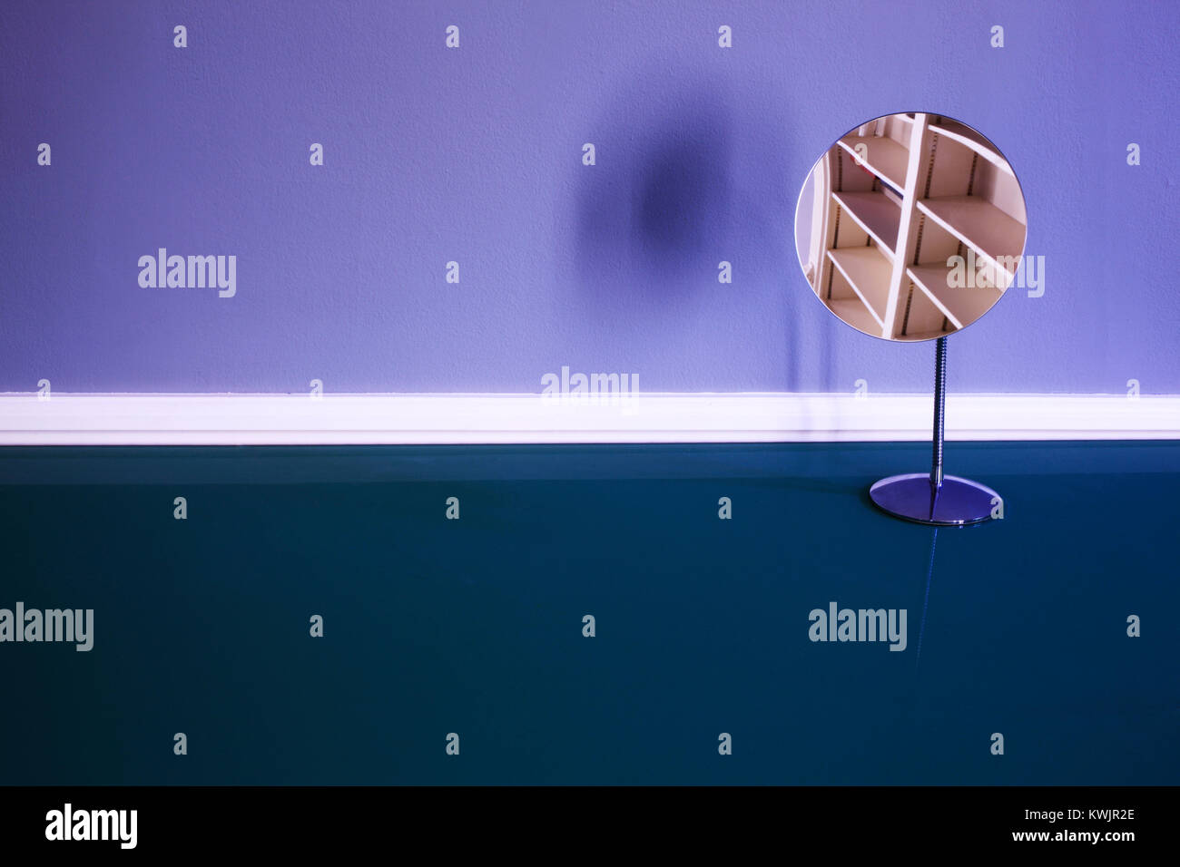 A reflection of empty shelves on a mirror on top of a table Stock Photo ...