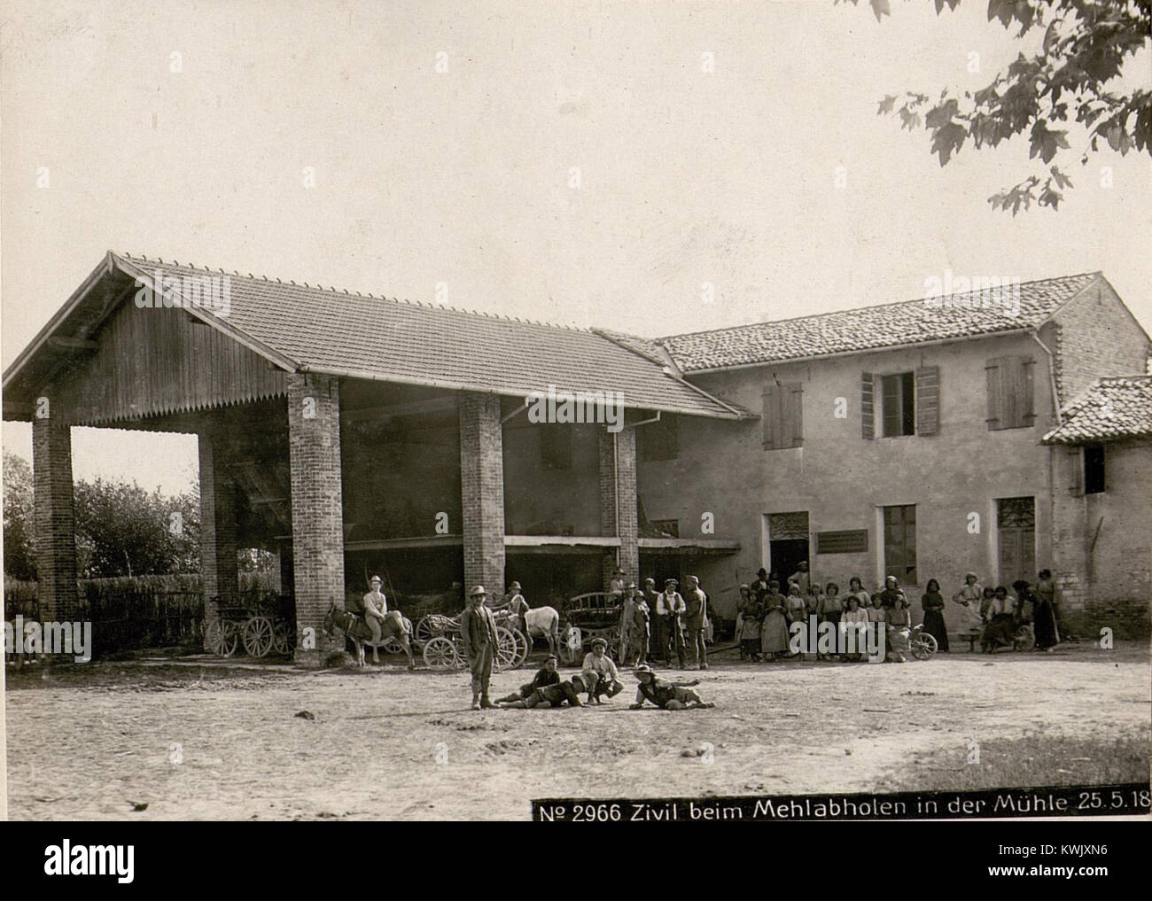 A historical photograph depicting civilians involved in wheat ...