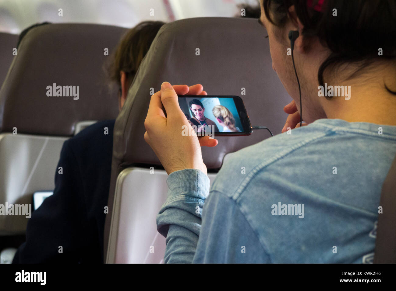 Economy flight watching film hi-res stock photography and images - Alamy