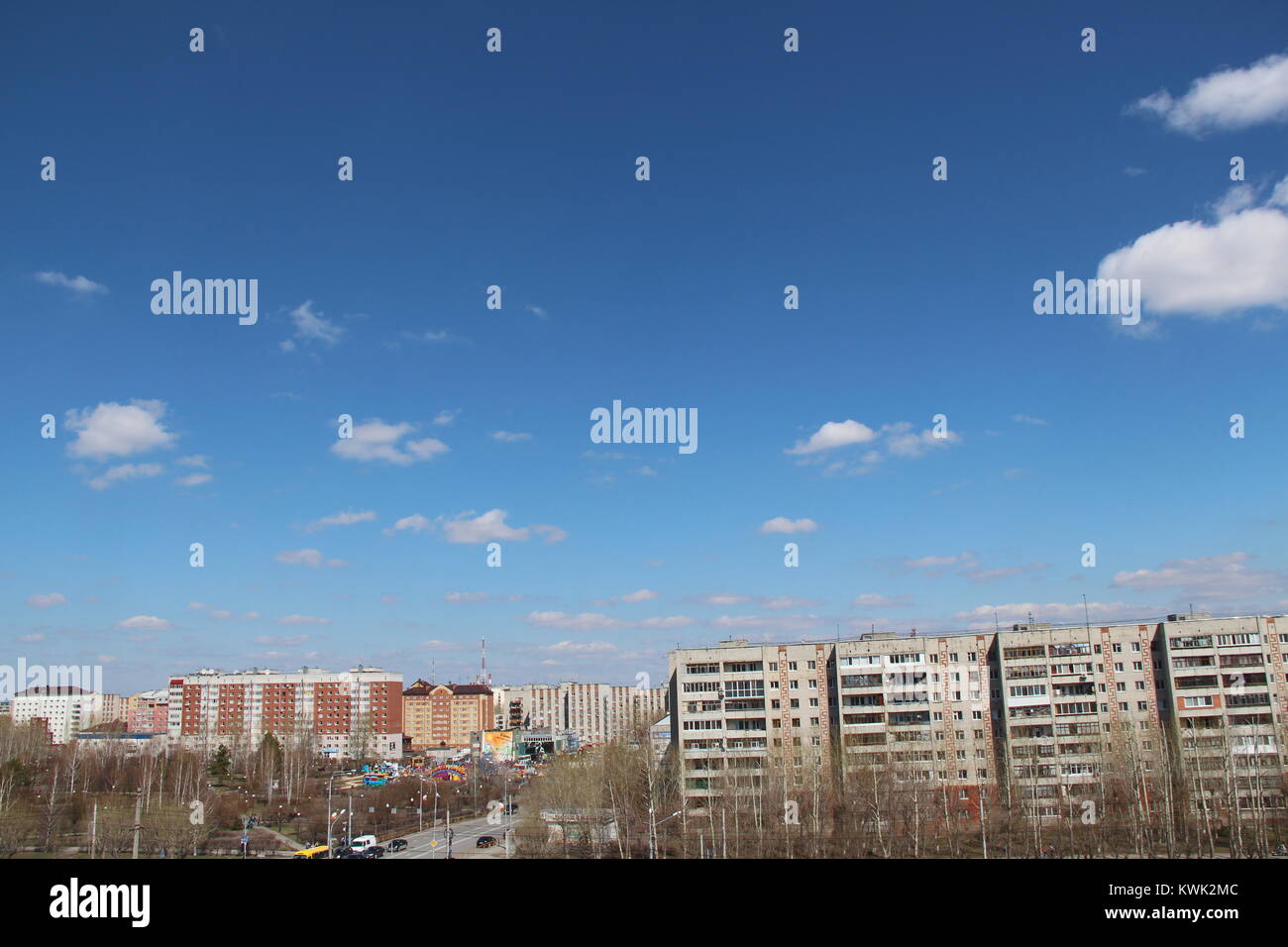 Blue clear day sky with white clouds and sunlight. A city landscape ...