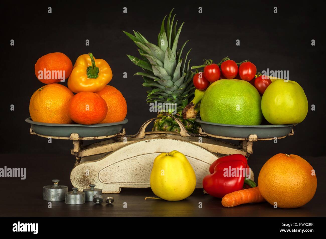 Old cast iron kitchen scale with fruit and vegetables. Healthy eating ...