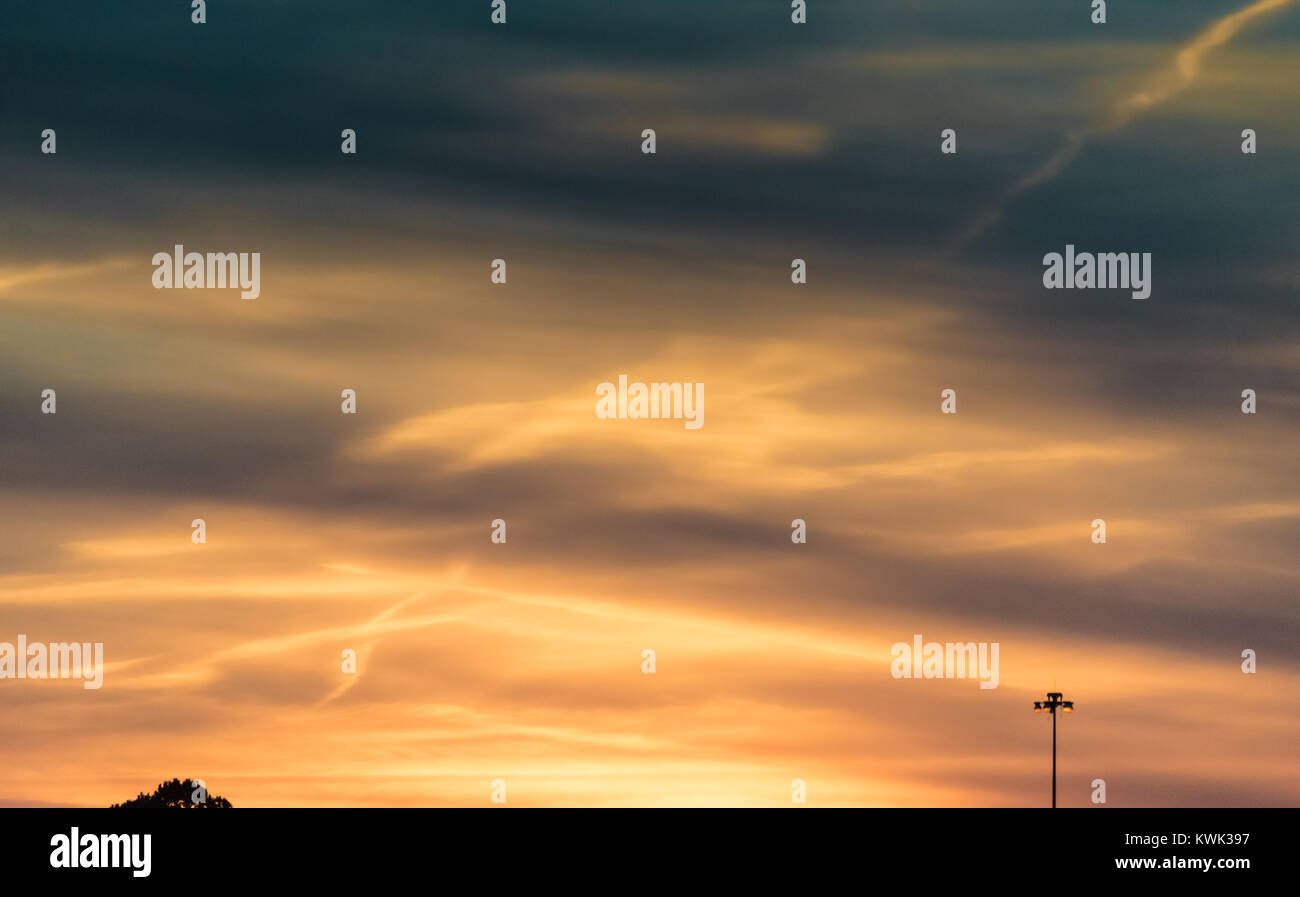 Lighted contrails in a dramatic sunset sky along US Highway 78 in ...