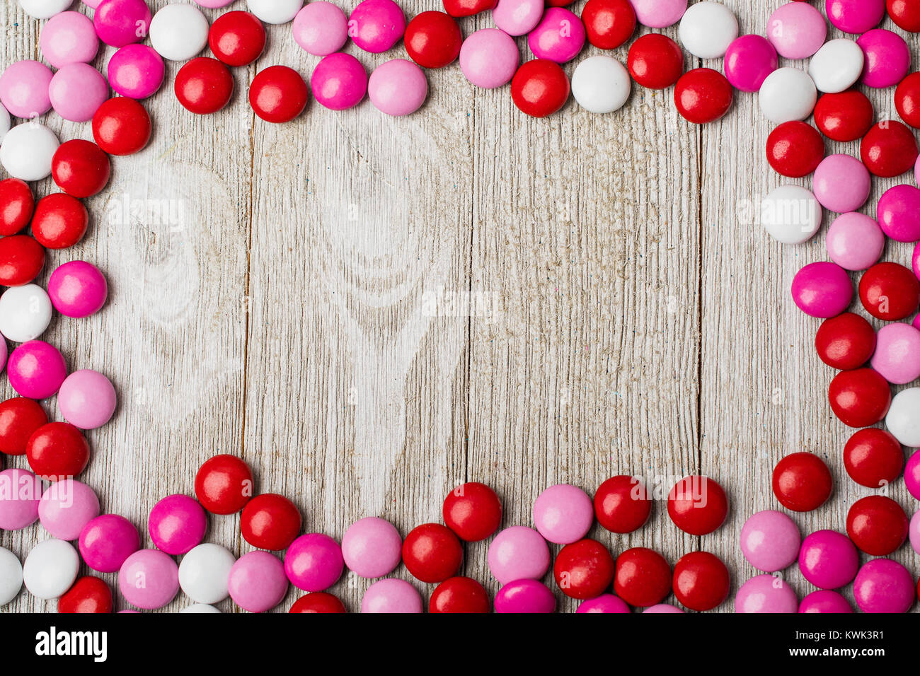 Red white and pink candy arranged on a white painted board Stock Photo ...