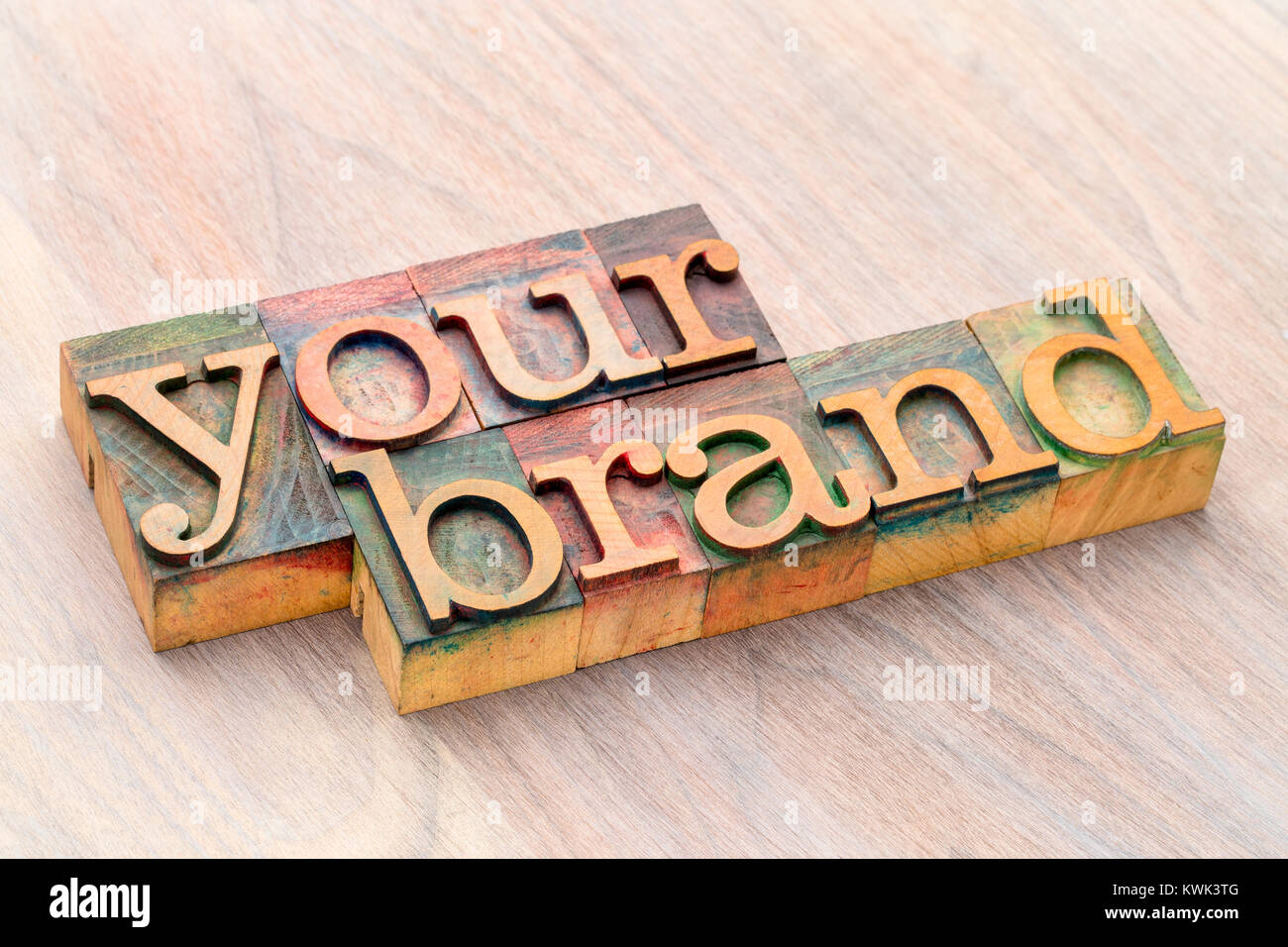 your brand word abstract in letterpress wood type against grained wood ...