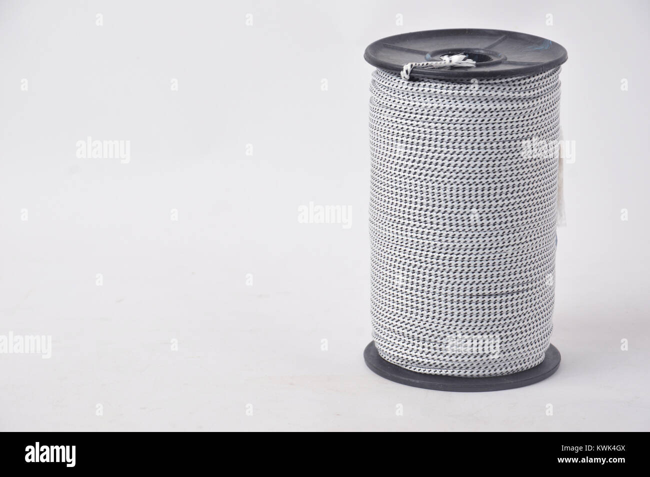 black and white spools of thread on white background Stock Photo - Alamy