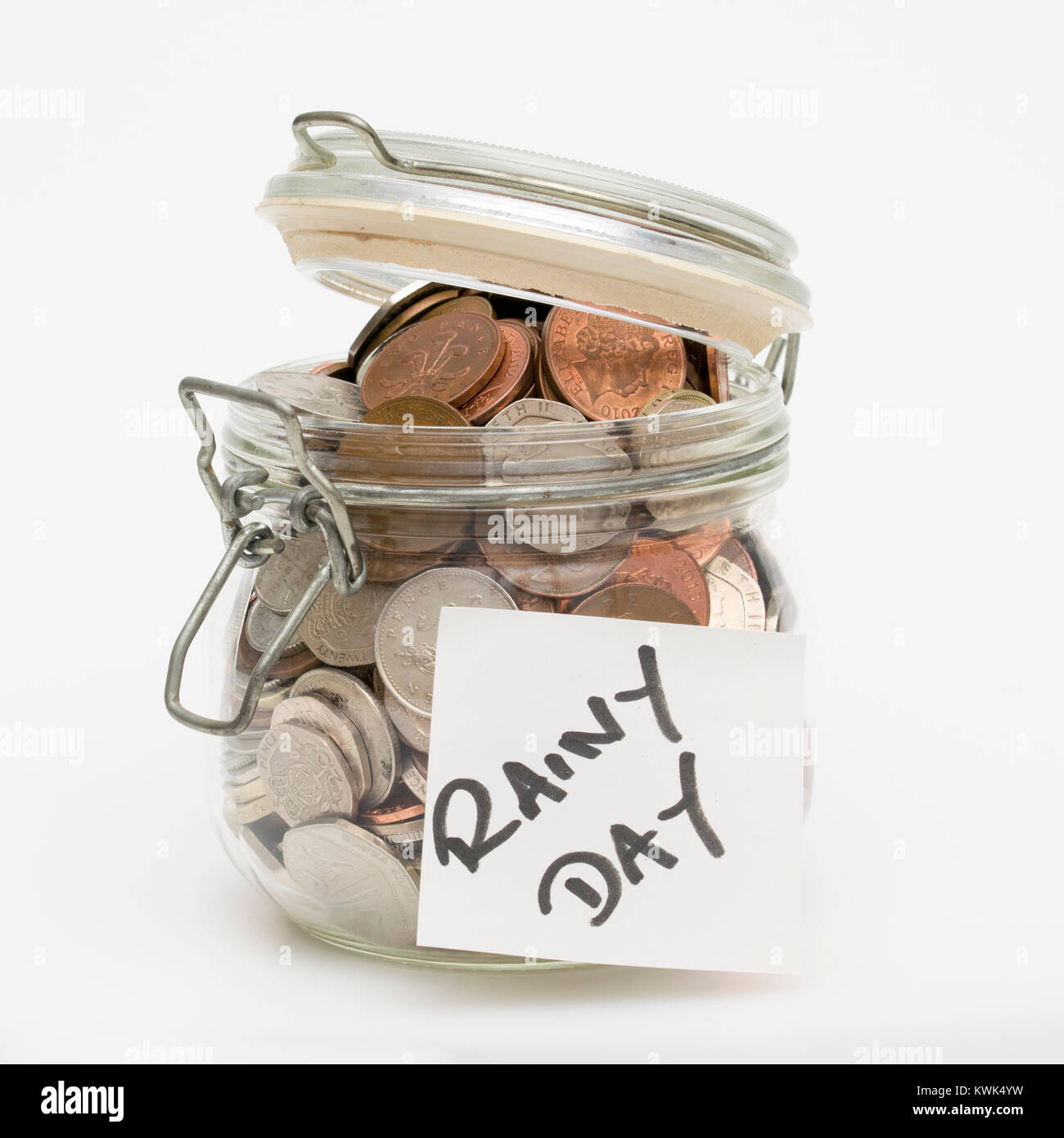 Rainy Day fund. Jar containing money ready for a rainy day. Coins are ...