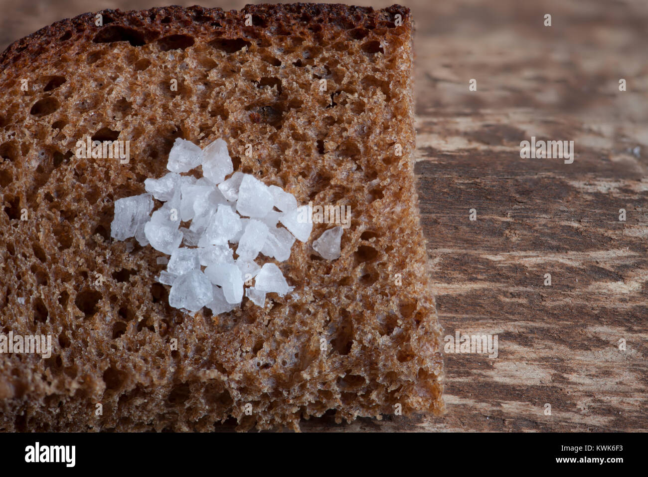 crystals of salt on a slice of rye bread,in olden times, bread and salt ...