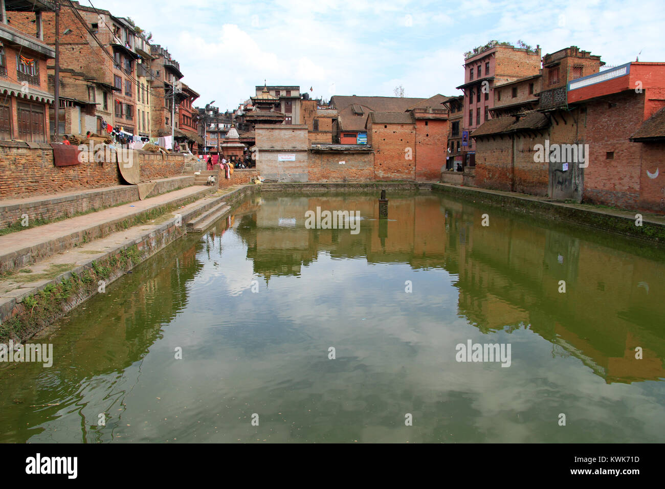 Pool with green water near houses in Bhaktapur in Nepal Stock Photo - Alamy