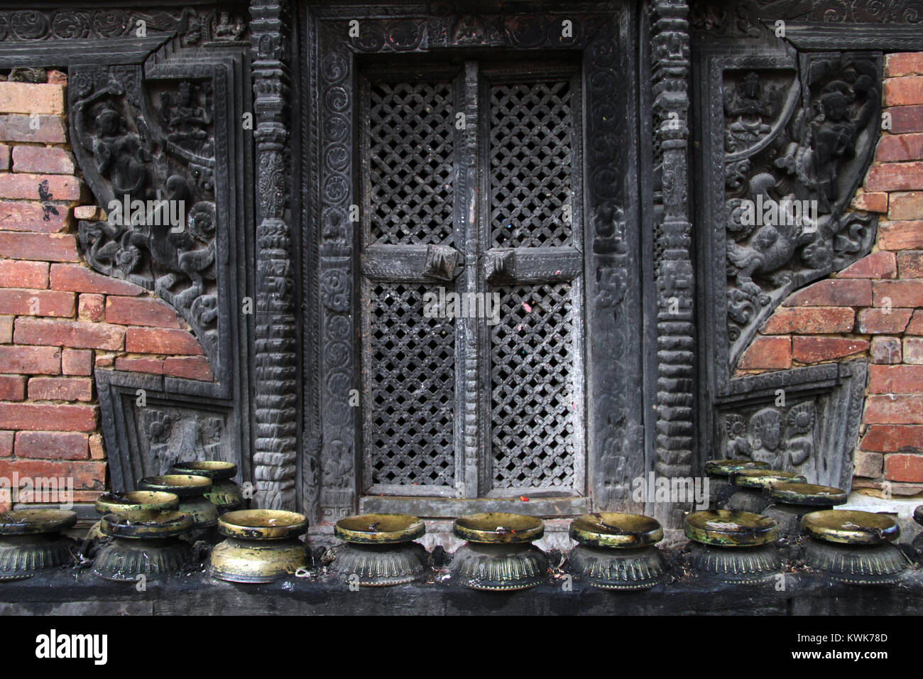 Wooden window and brick wall of hindu temple, Nepal Stock Photo - Alamy