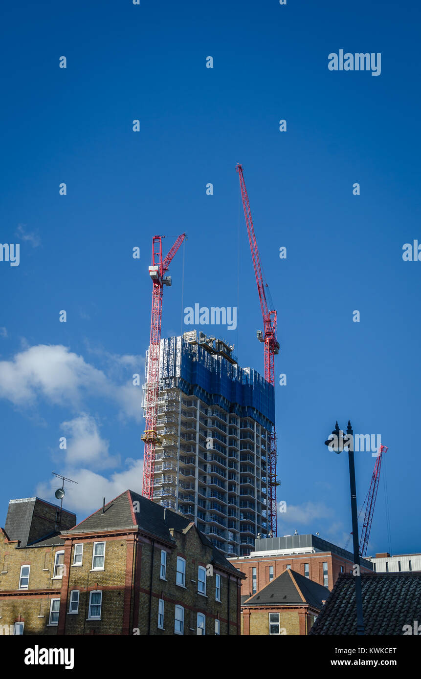 Skyscraper construction with working crane Stock Photo - Alamy