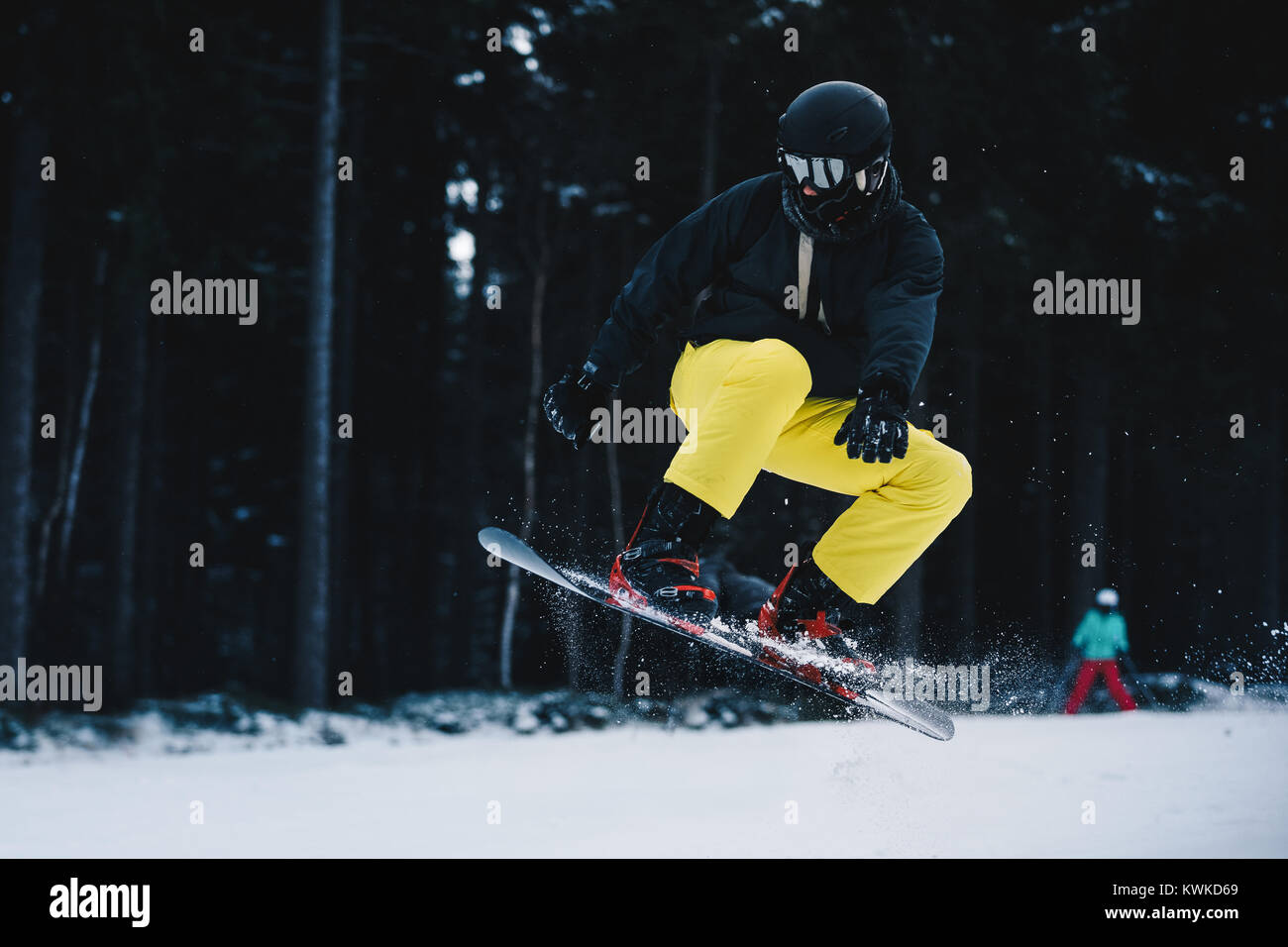 Snowboard Freestyle Jump. Snowboarder Jumping Through Air with Dark ...