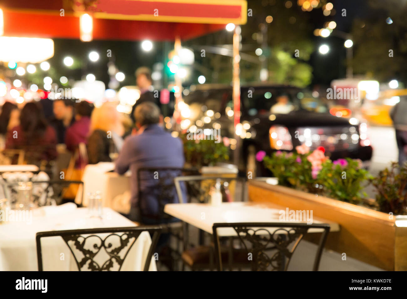Defocused blur of outdoor restaurant scene with non recognizable diners ...
