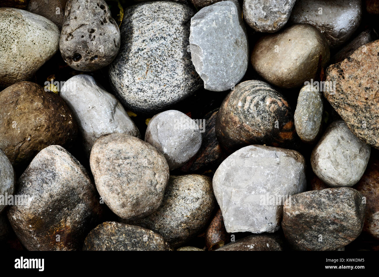Close up of river rock showing various textures, shapes and colors ...